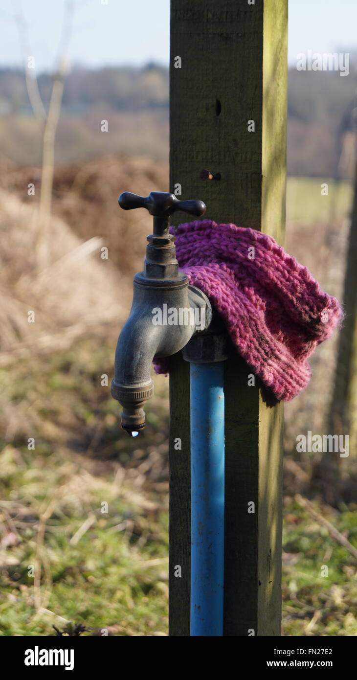 Outdoor water tap attached to wooden post Stock Photo - Alamy