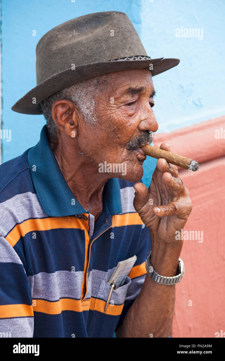 Daily life in Cuba - Cuban man smoking cigar at Trinidad, Cuba, West ...
