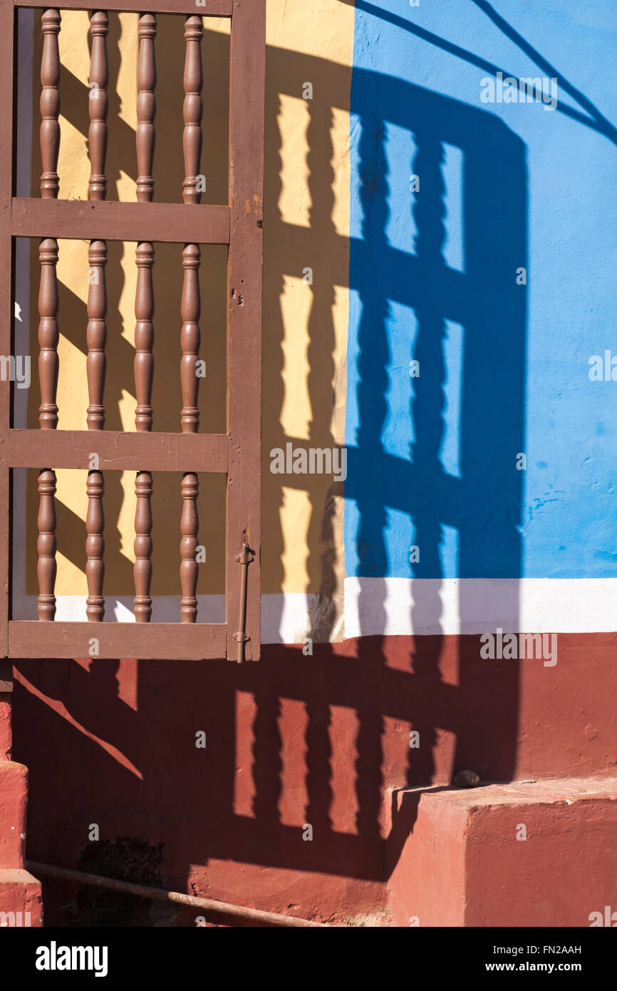 Shadows of spindles of window shutter on wall at Trinidad, Cuba, West ...