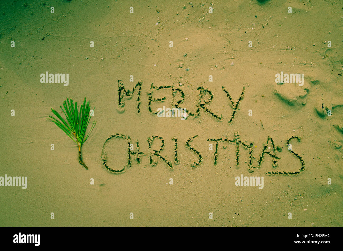 merry christmas written into sand Stock Photo - Alamy