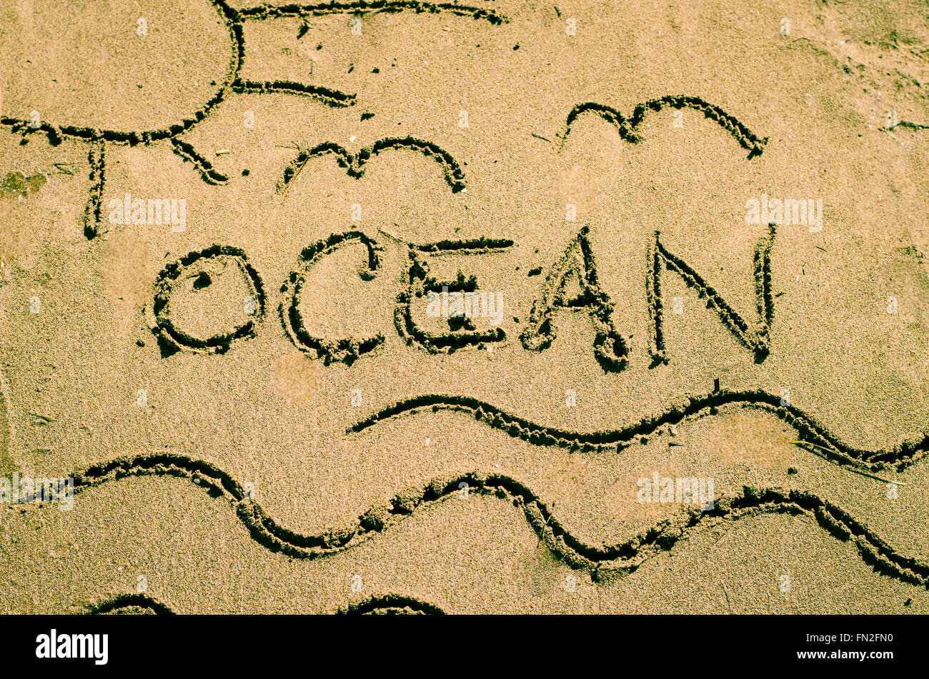 ocean words drown into sand on beach Stock Photo - Alamy
