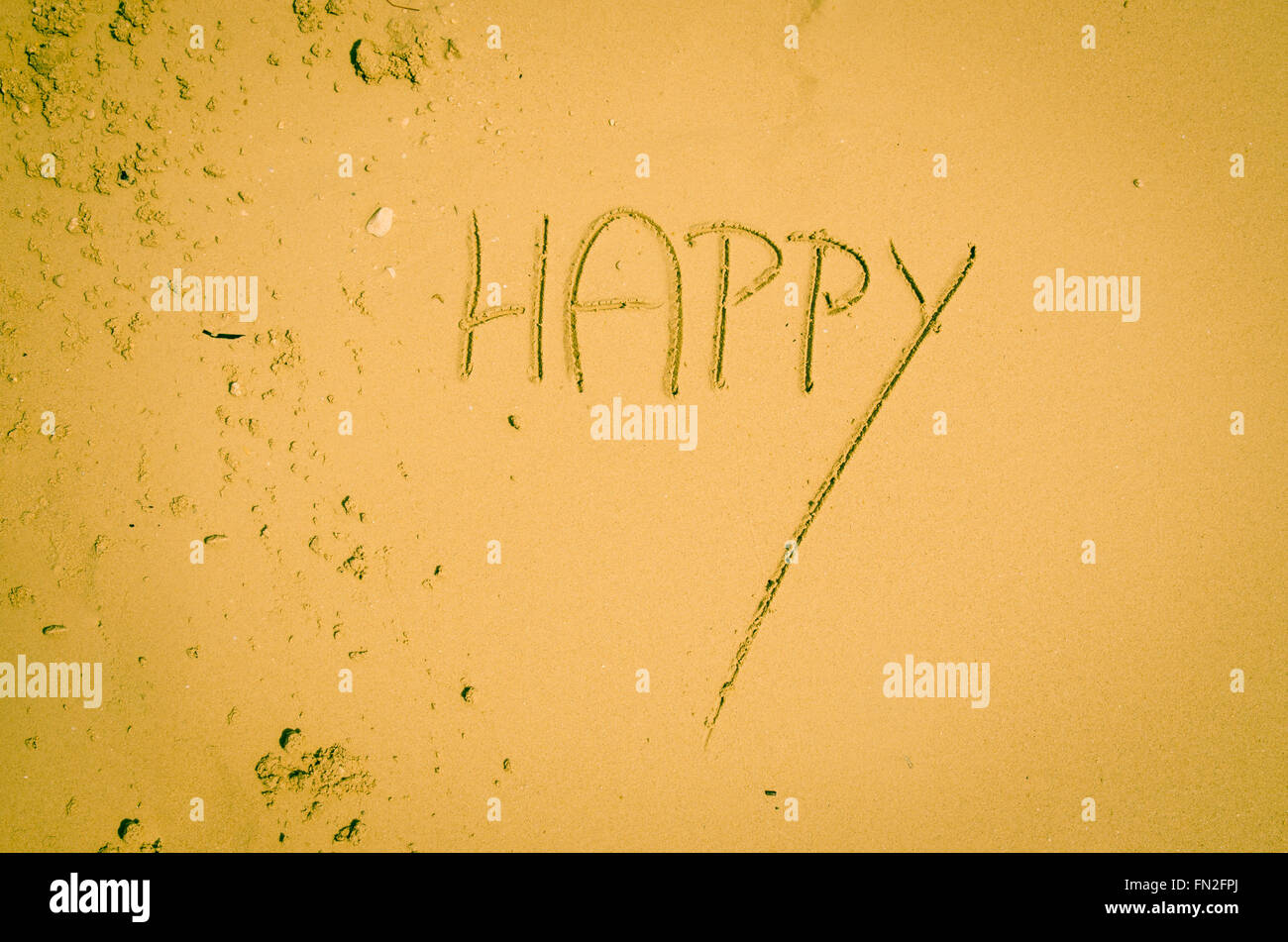 word happy written into sand Stock Photo - Alamy