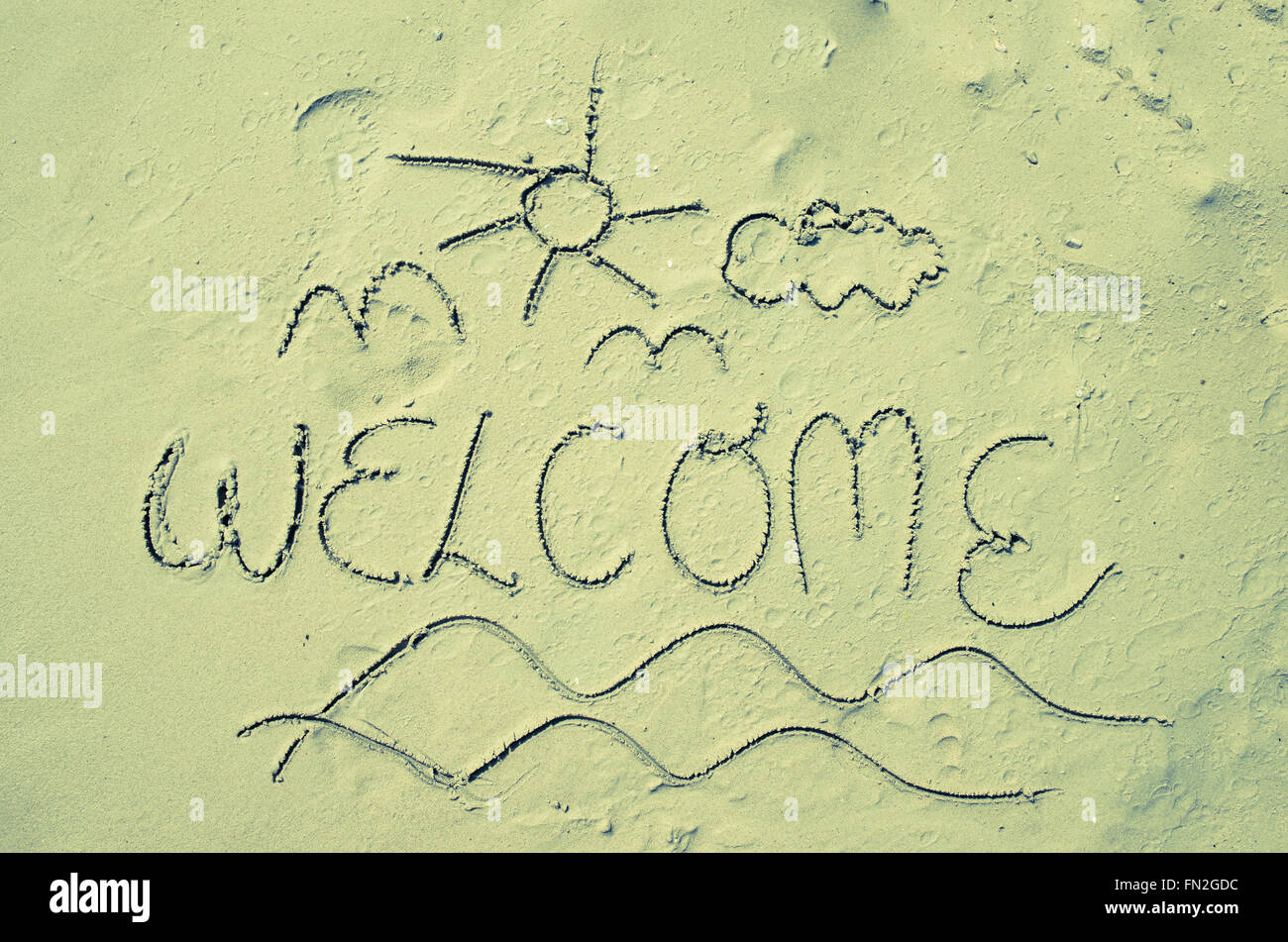 word welcome written into sand Stock Photo - Alamy