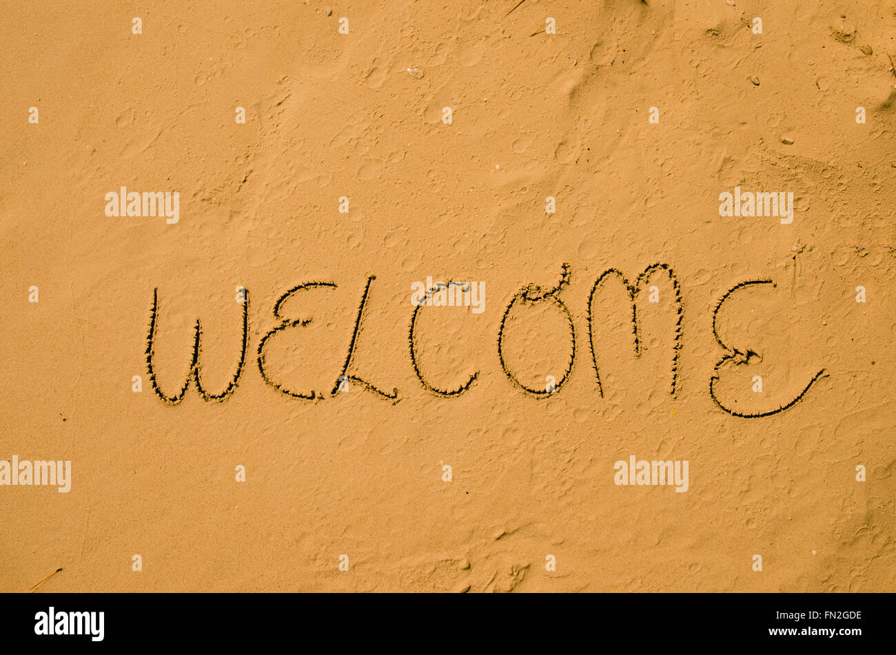 word welcome written into sand Stock Photo - Alamy