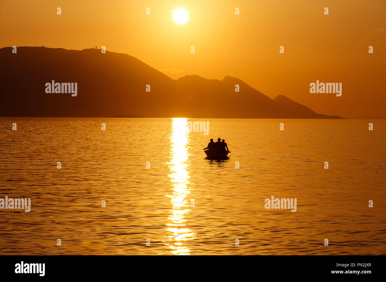 yellow sunset over sea and boat Stock Photo - Alamy