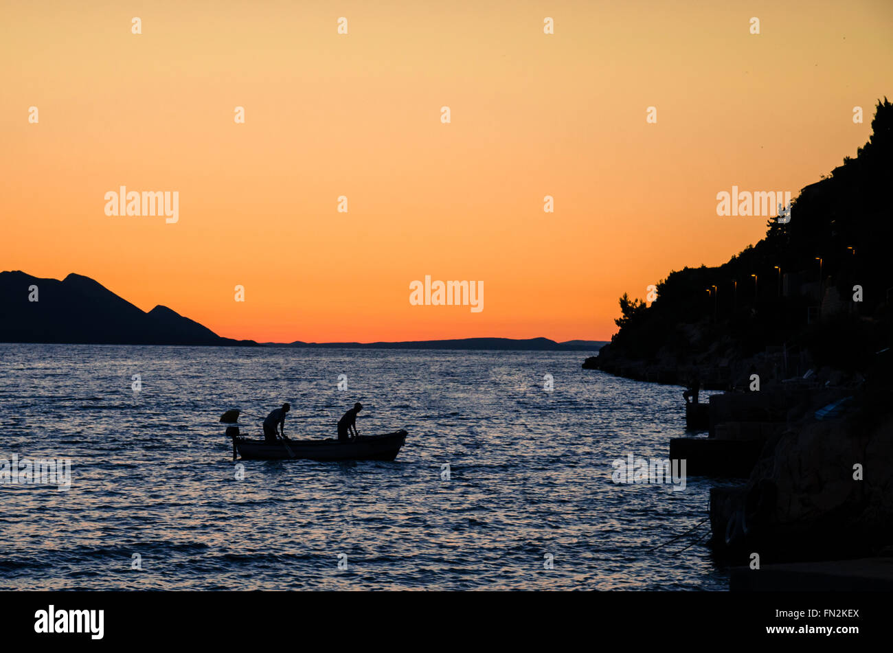 fishmen in boat on sea Stock Photo - Alamy