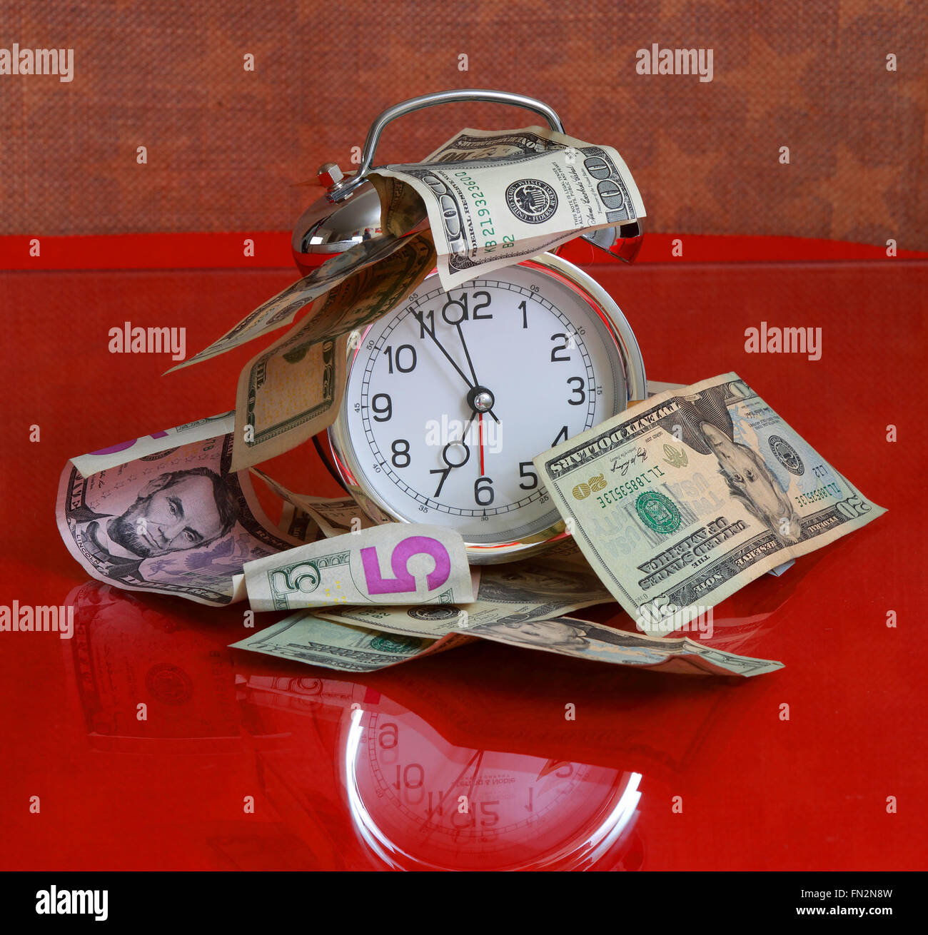 Time is money concept - clock and dollars Stock Photo - Alamy