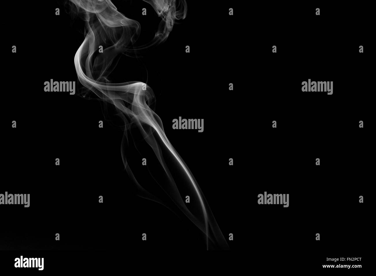 A thick streak of white, grainy smoke on a black background with the ...