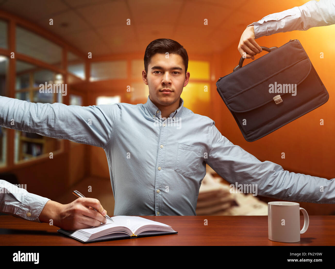 Man doing many tasks Stock Photo - Alamy