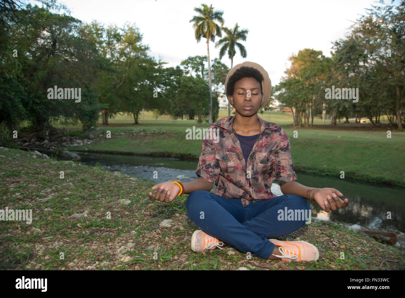 Young African American woman meditating in the outdoors Stock Photo - Alamy