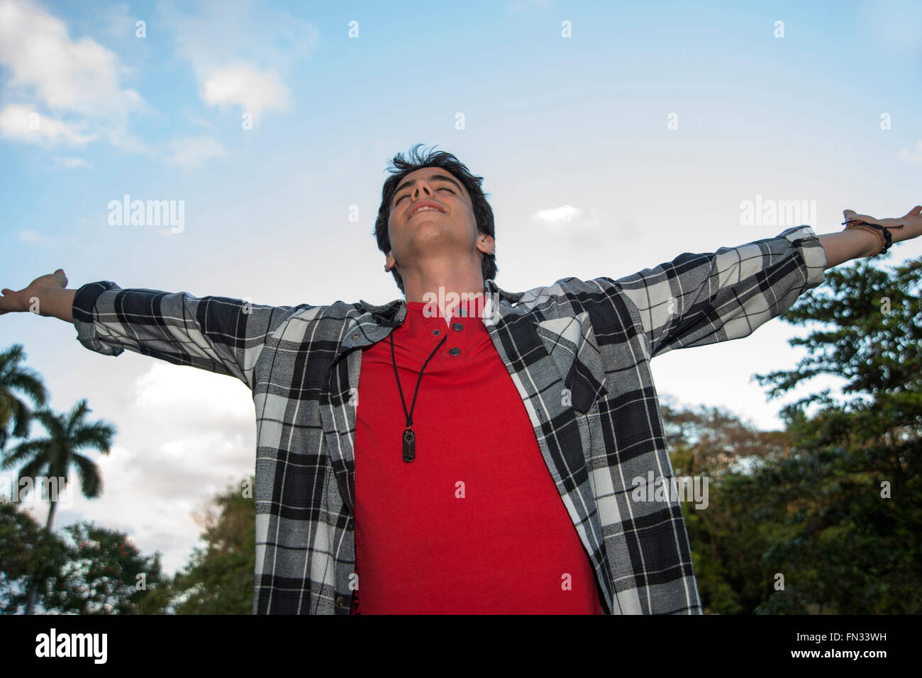 Young man with open arms in the outdoors Stock Photo - Alamy