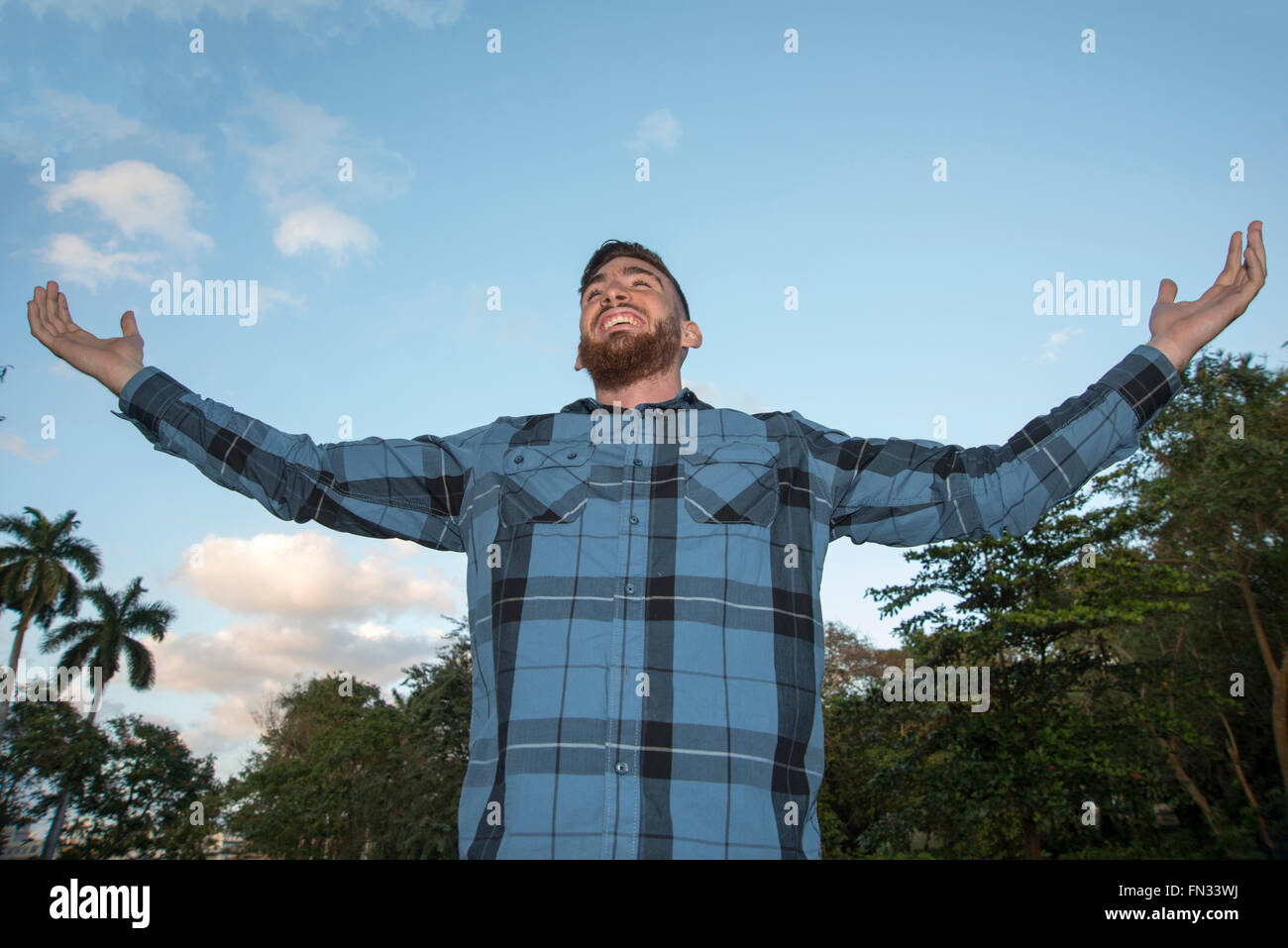 Young man with open arms in the outdoors Stock Photo - Alamy