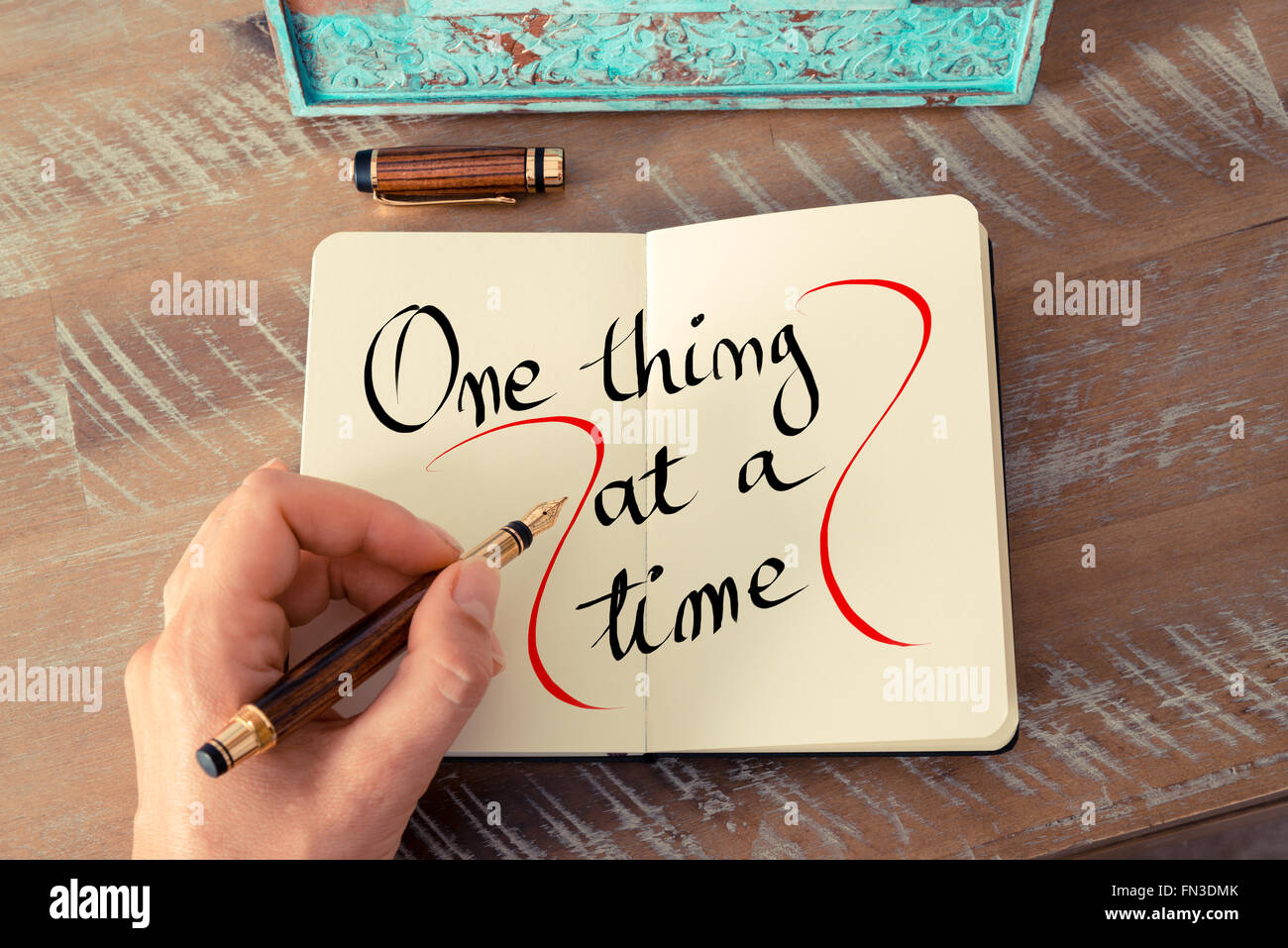 Retro effect and toned image of a woman hand writing a note with a ...