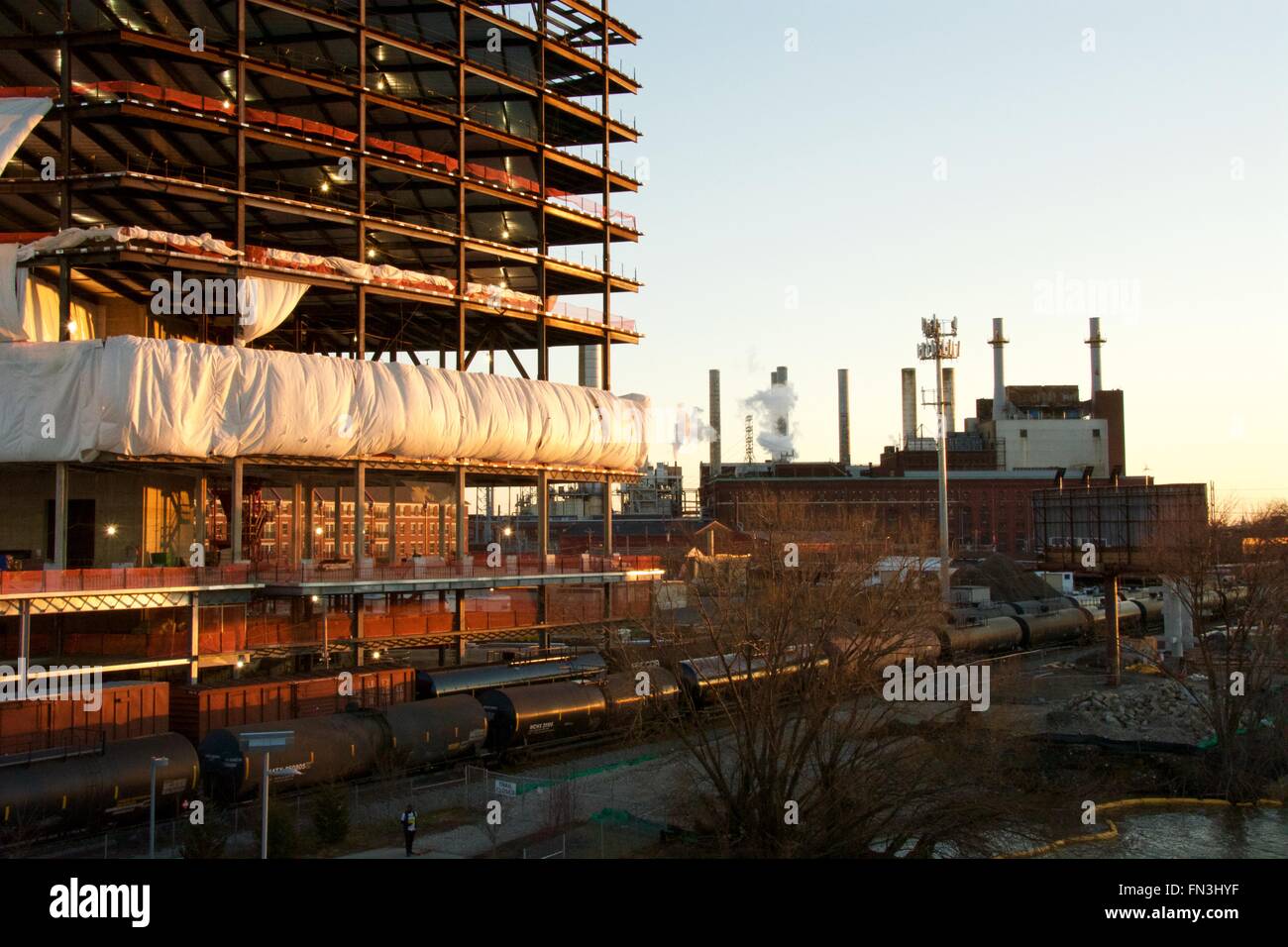 A train idles by a building under construction, Philadelphia PA Stock ...