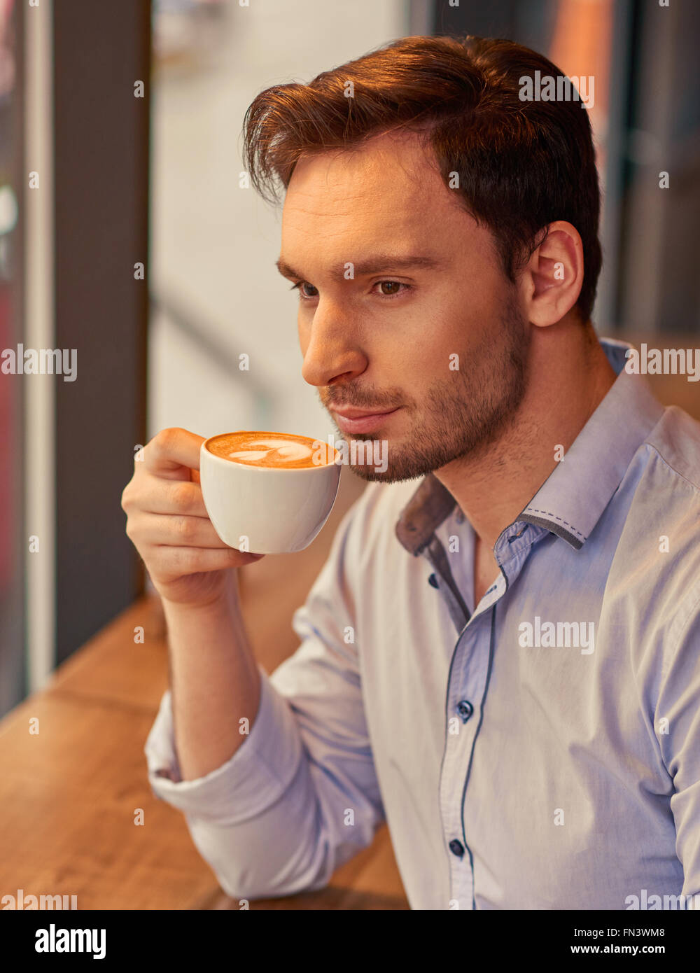 Handsome man drinking coffee Stock Photo - Alamy