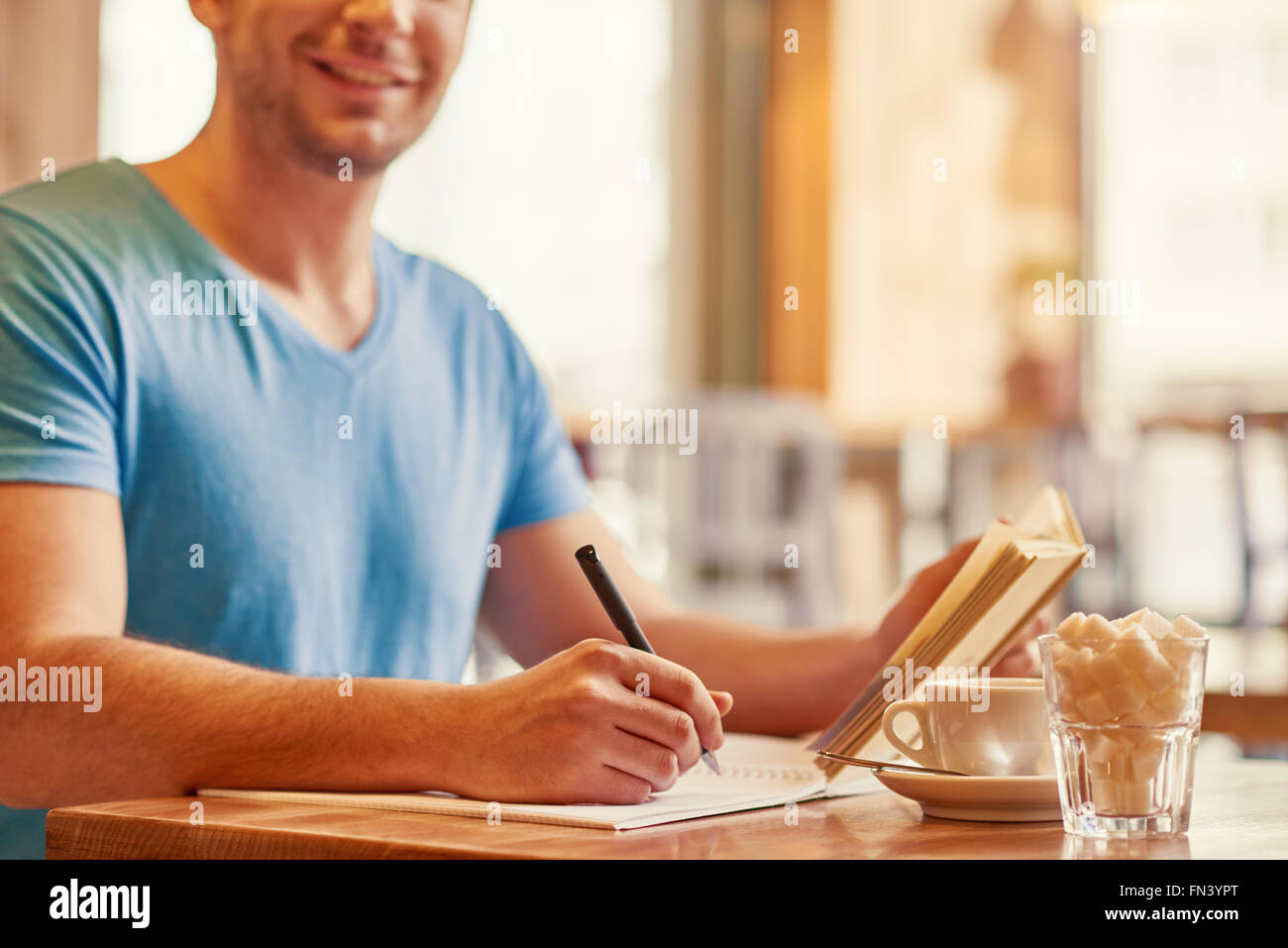 Cheerful man making notes Stock Photo - Alamy