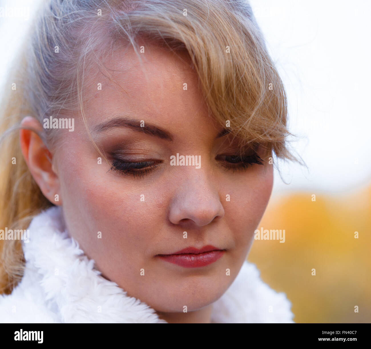 Sad woman walking in fall forest park. Gorgeous blonde young girl ...