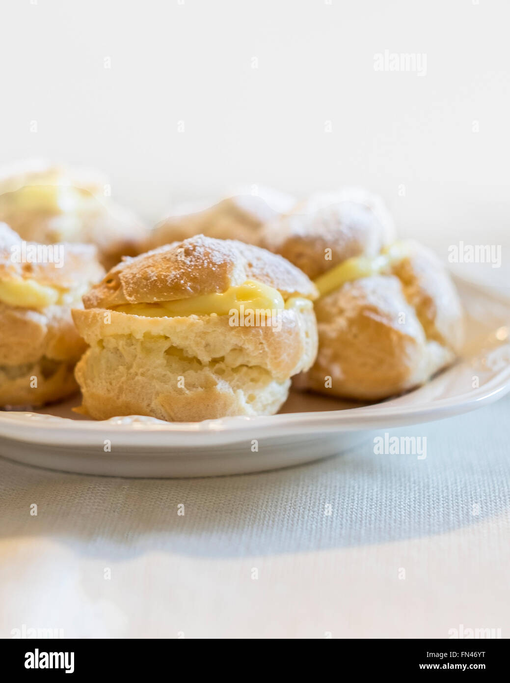 Homemade cream puffs on a white plate Stock Photo - Alamy