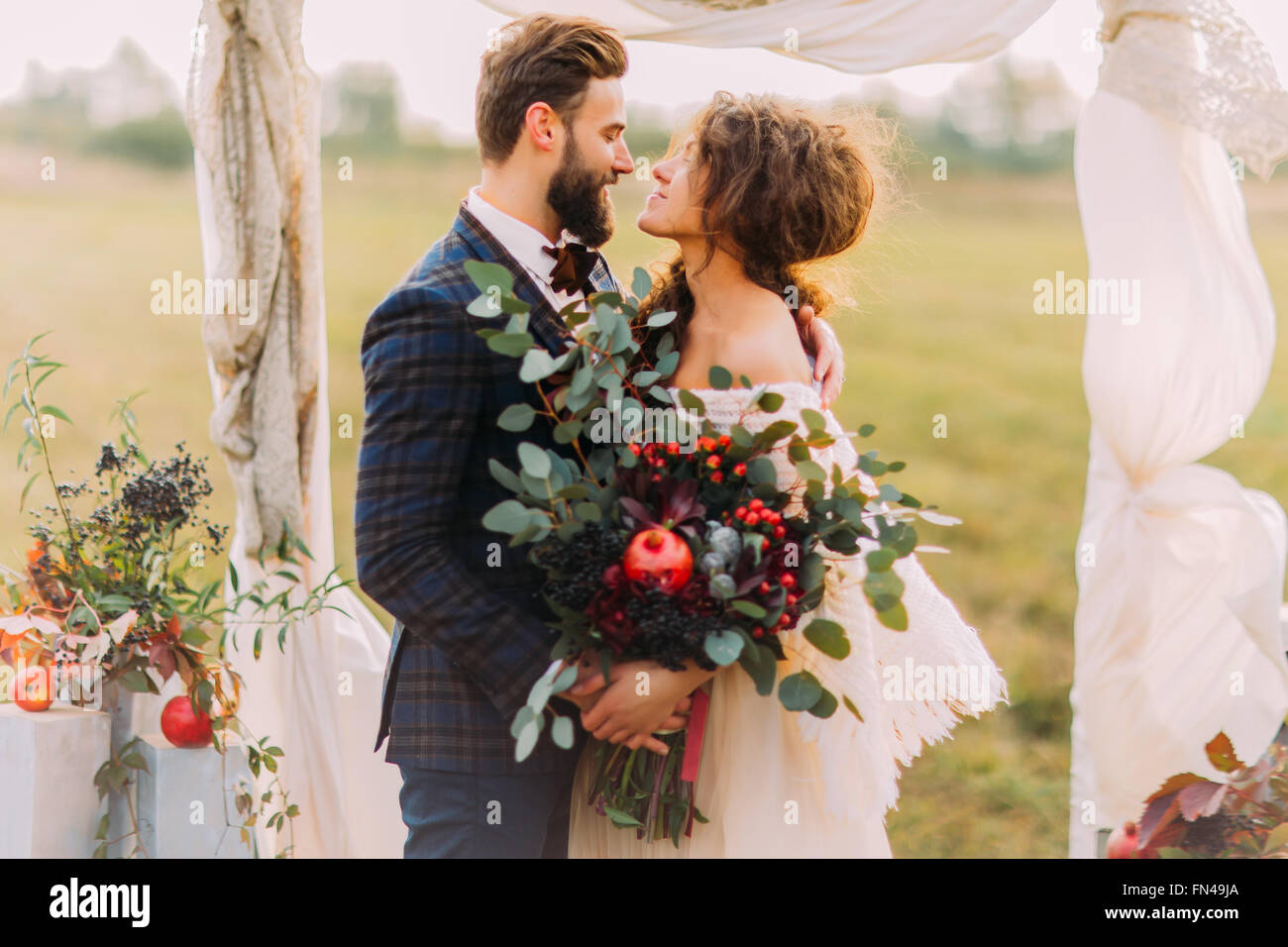 Wedding couple lovingly look at each other during ceremony Stock Photo ...