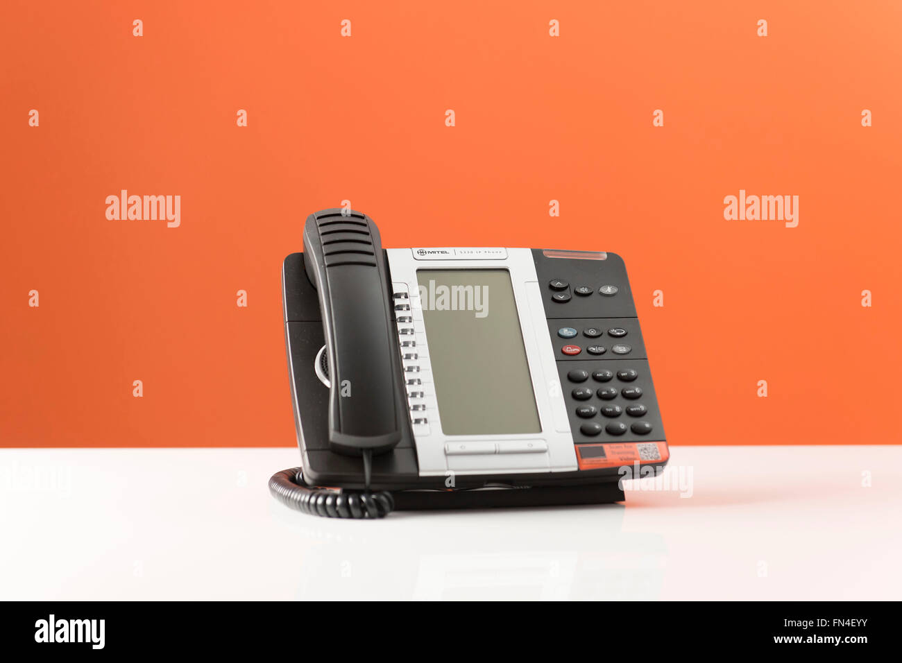 Office phone on an orange background Stock Photo - Alamy
