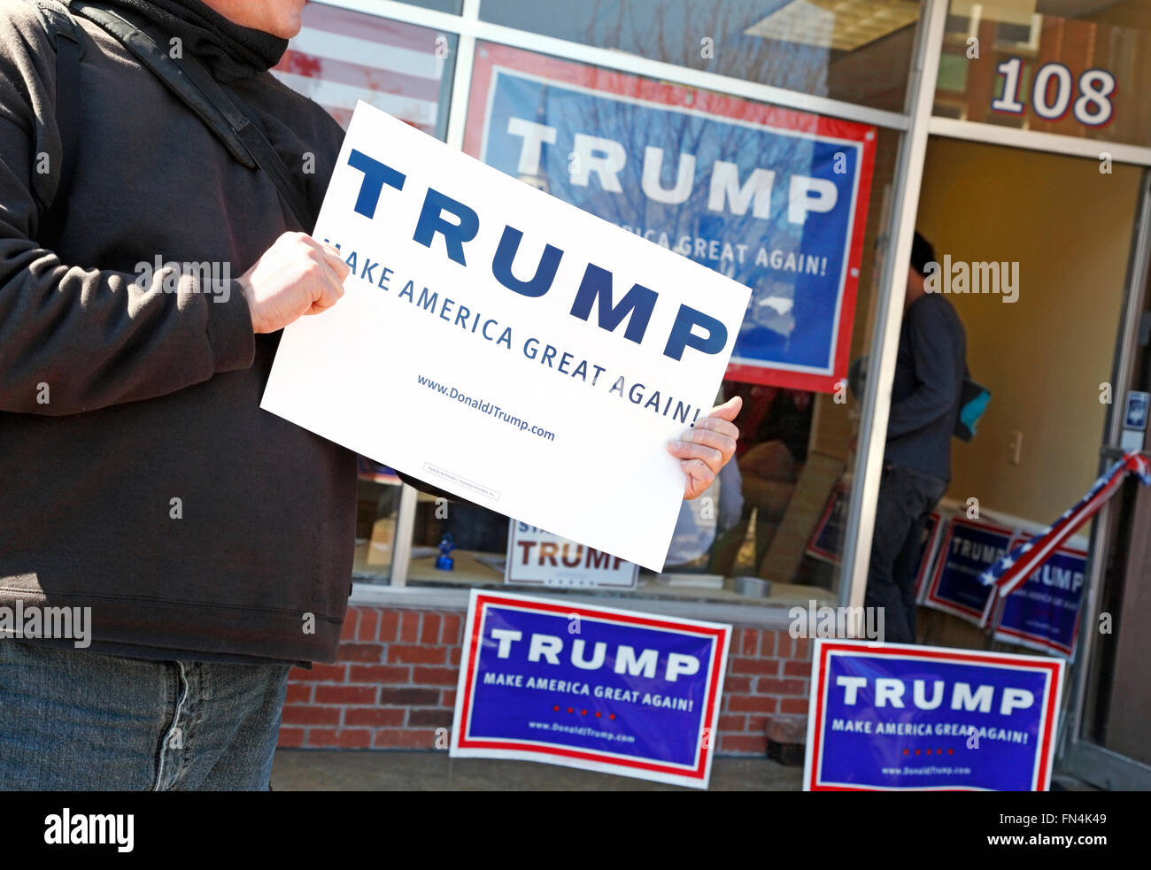 Man holding TRUMP sign outside Donald Trump's campaign office in ...