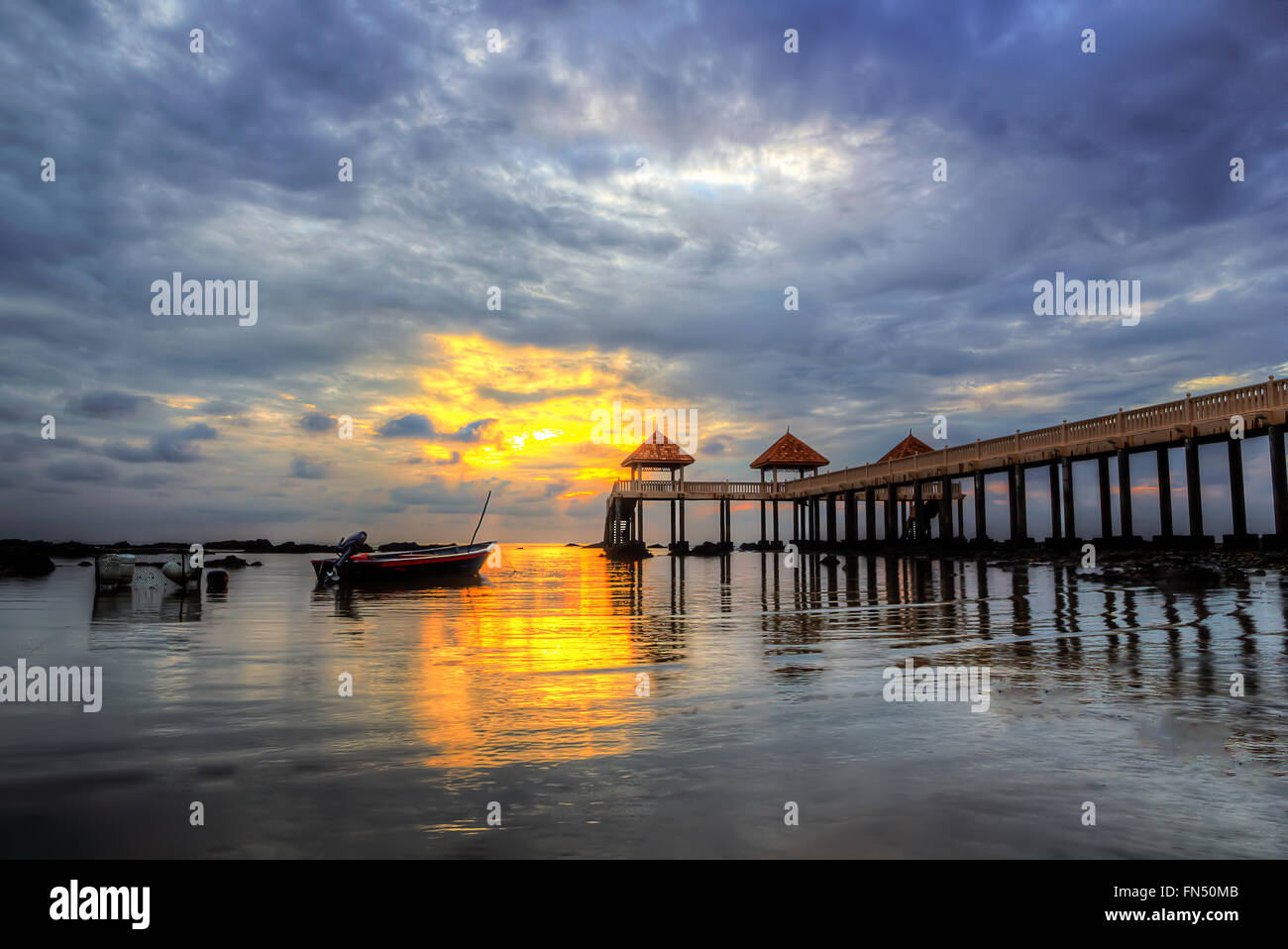 boat at beach in sunrise Stock Photo - Alamy