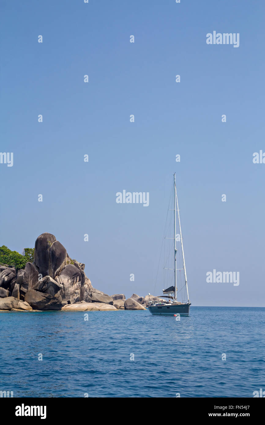 sailboat and giant rock on the sea Stock Photo - Alamy