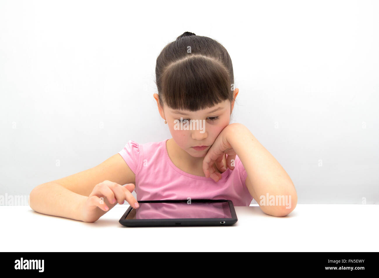 Little girl using a tablet pc Stock Photo - Alamy