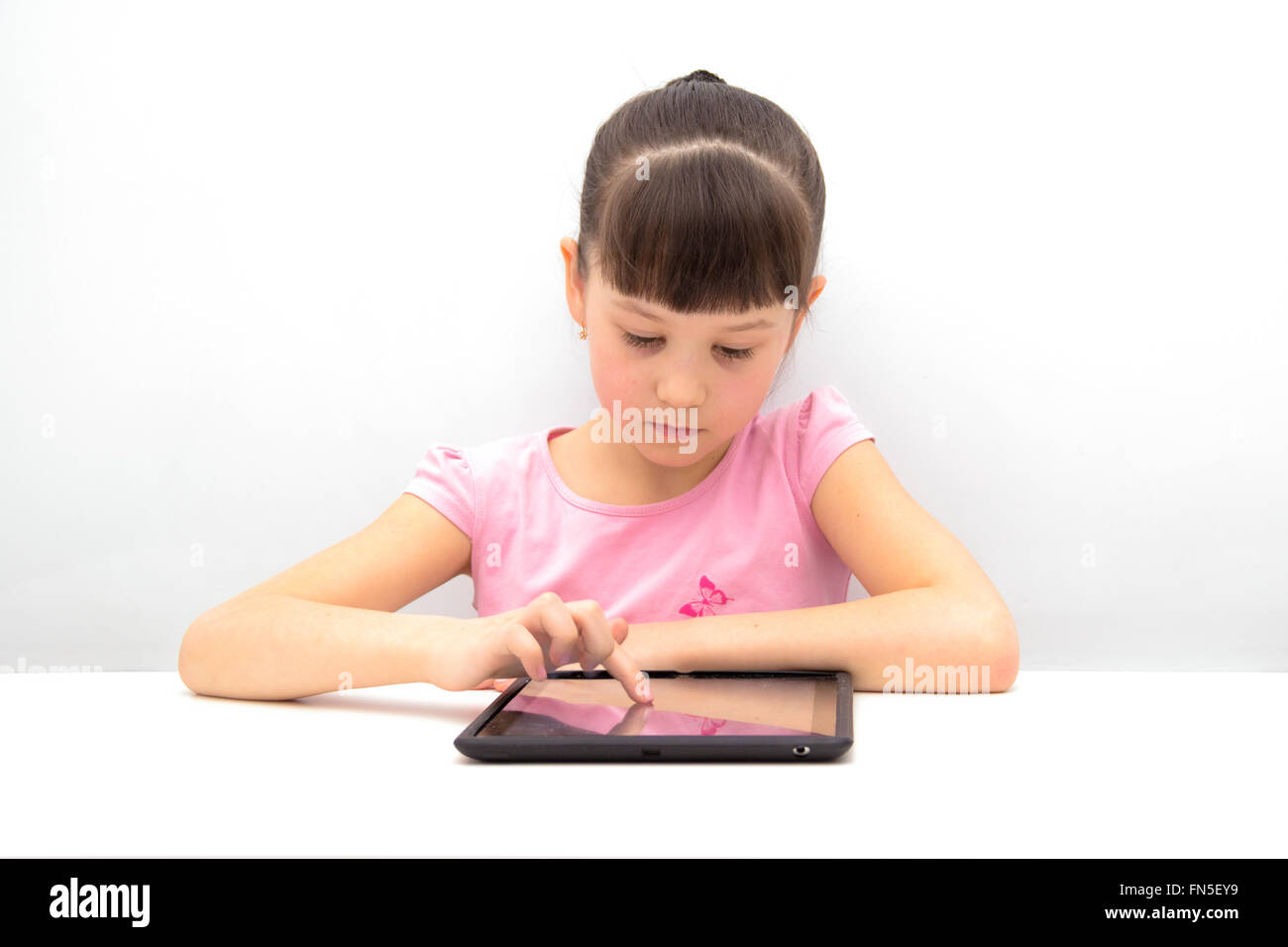 Little girl using a tablet pc Stock Photo - Alamy