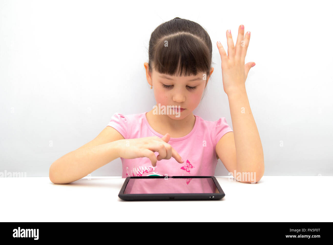 Little girl using a tablet pc Stock Photo - Alamy