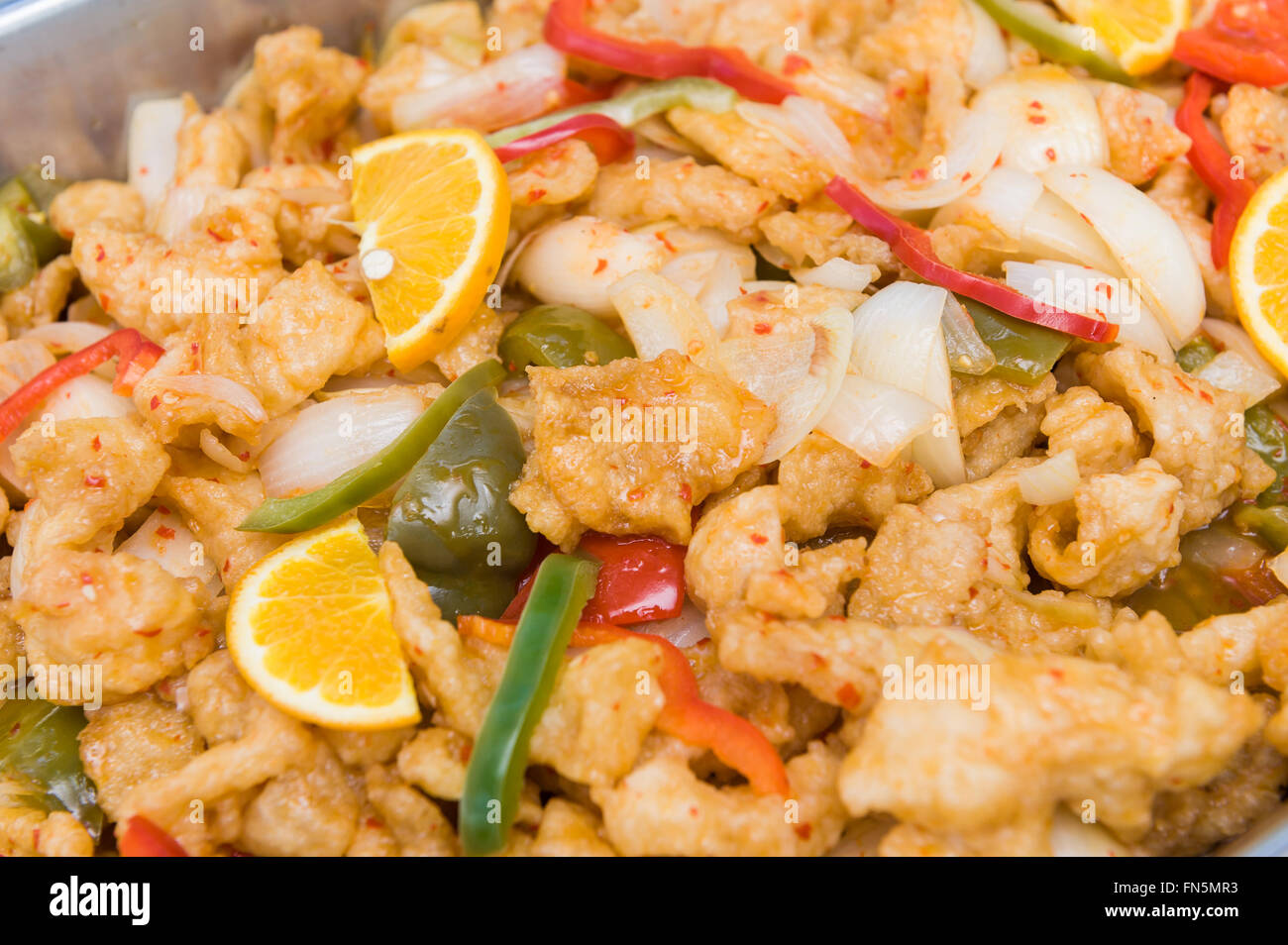 Close up of sweet and sour chicken dish topped with spices Stock Photo ...
