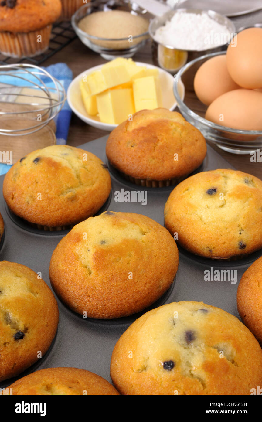 Freshly baked muffins with ingredients on a wood table Stock Photo - Alamy