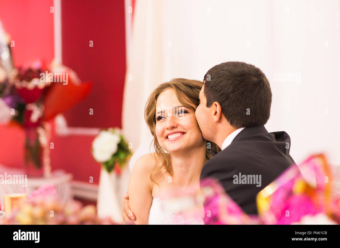 Newlyweds sitting together. Celebration, wedding reception in a ...