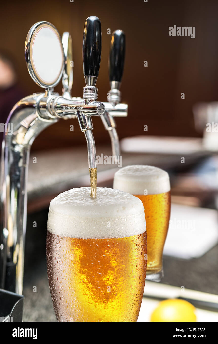 The process of pouring beer into the glass Stock Photo - Alamy