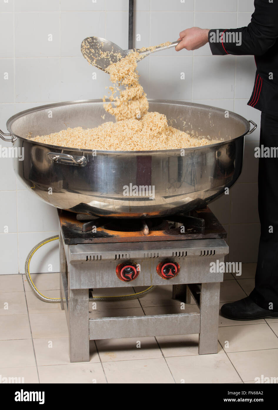 chef cooking rice at a commercial kitchen Stock Photo - Alamy