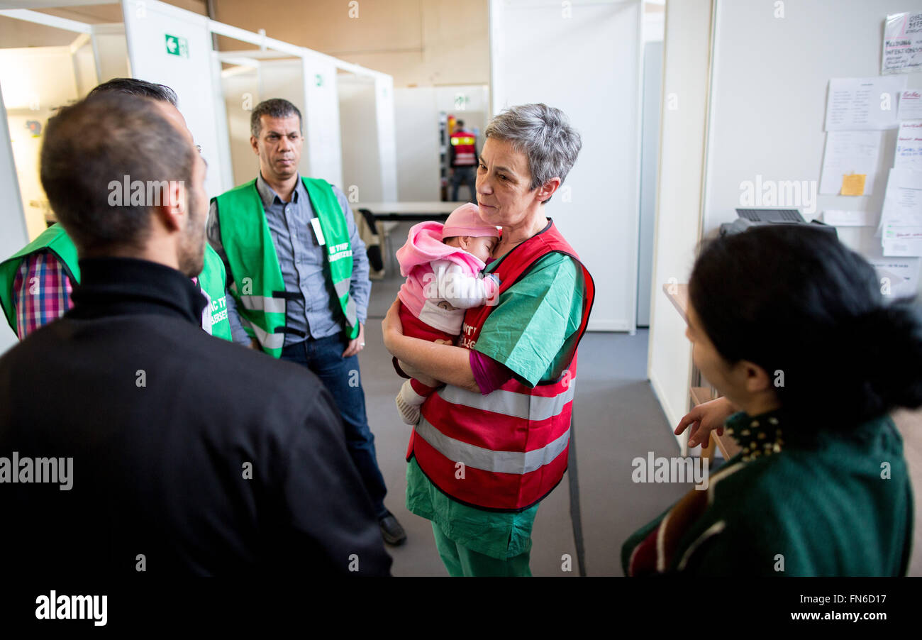 A nurse taking care of a sick refugee child at the Medical Center at ...