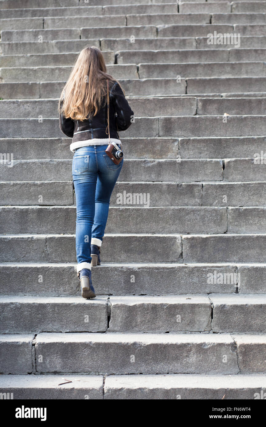 Young woman with old camera steps upstairs at the outdoor Stock Photo ...
