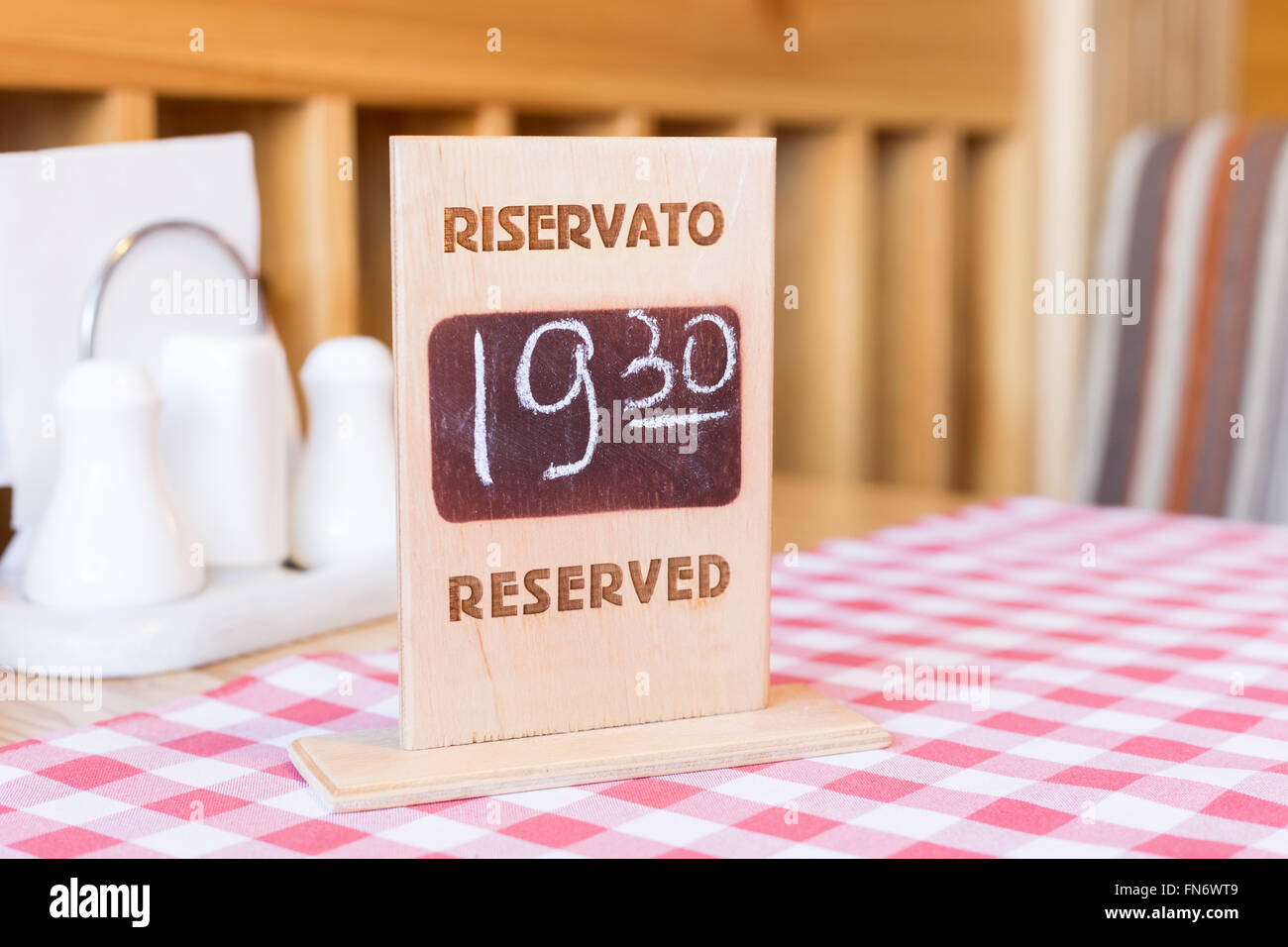 Wooden board with table reservation information in restaurant. Table ...