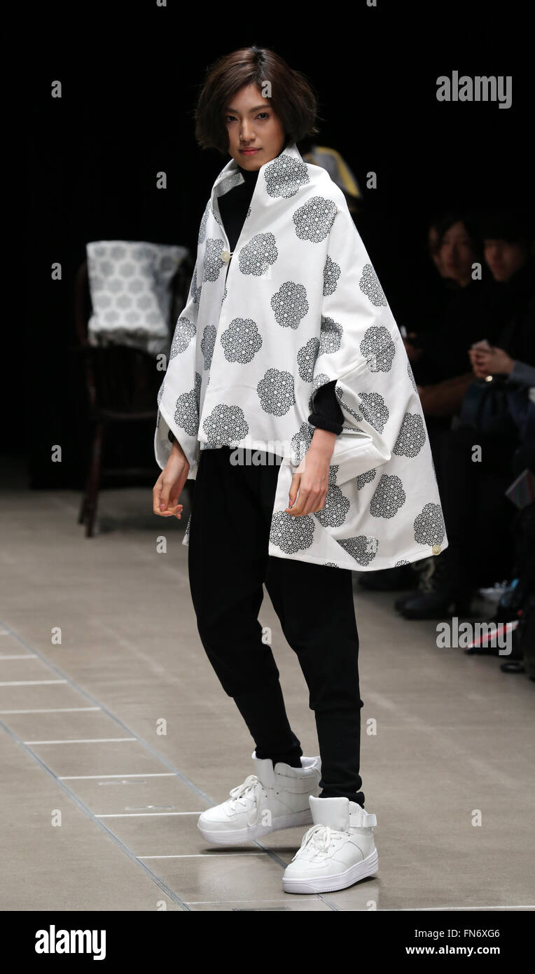 Tokyo, Japan. 14th Mar, 2016. A model displays a creation designed by ...