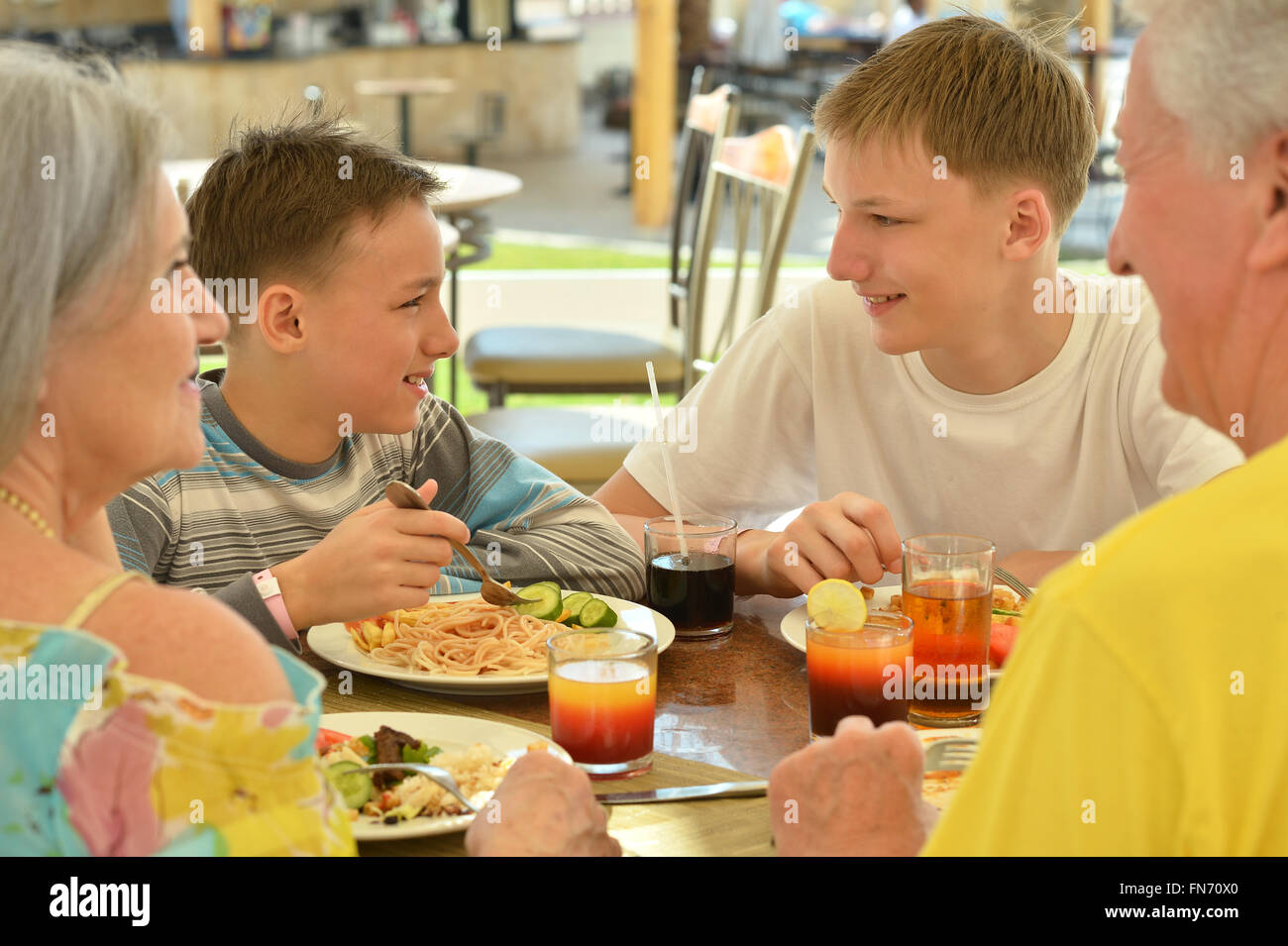 Grandparents with grandchildren at breakfast Stock Photo - Alamy