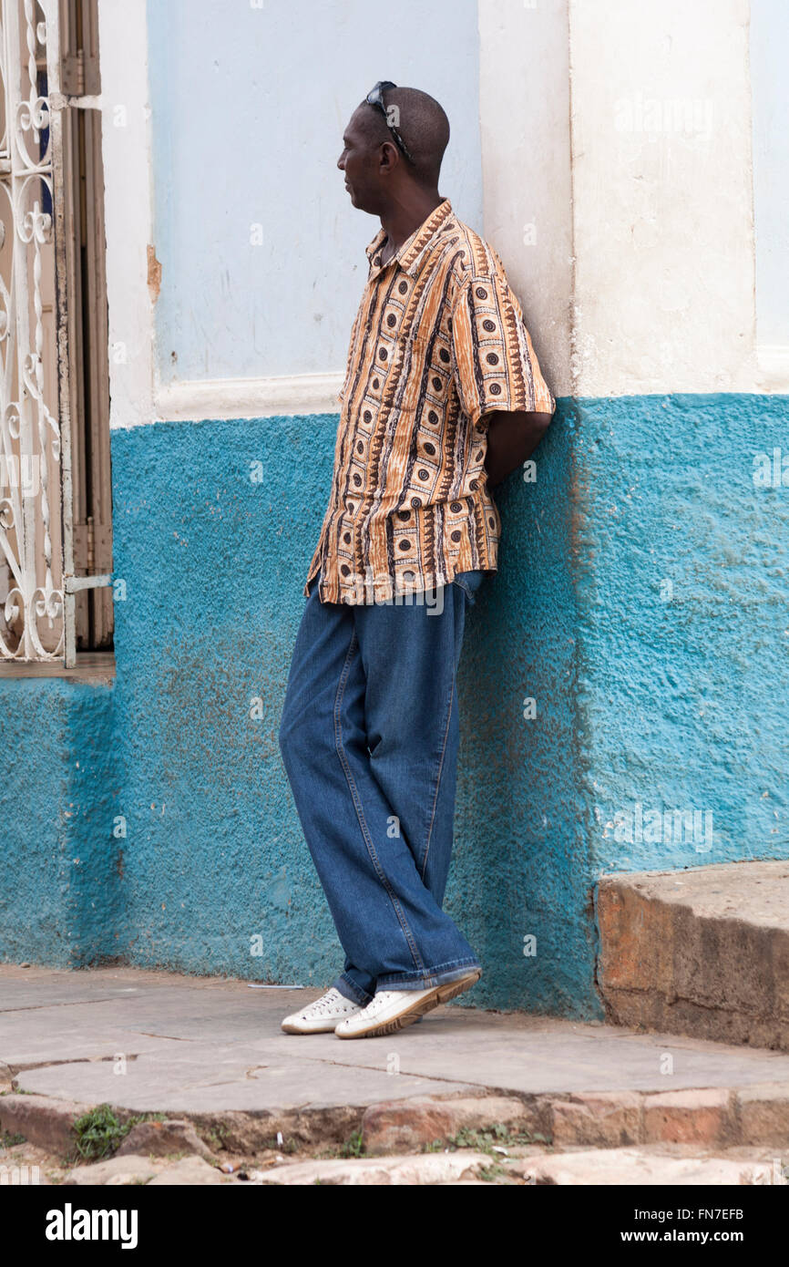 Daily life in Cuba - man standing against wall at Trinidad, Cuba, West ...