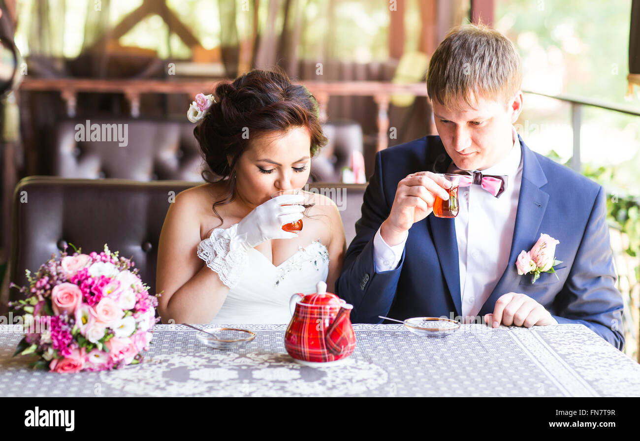 Groom and bride are drinking tea Stock Photo - Alamy