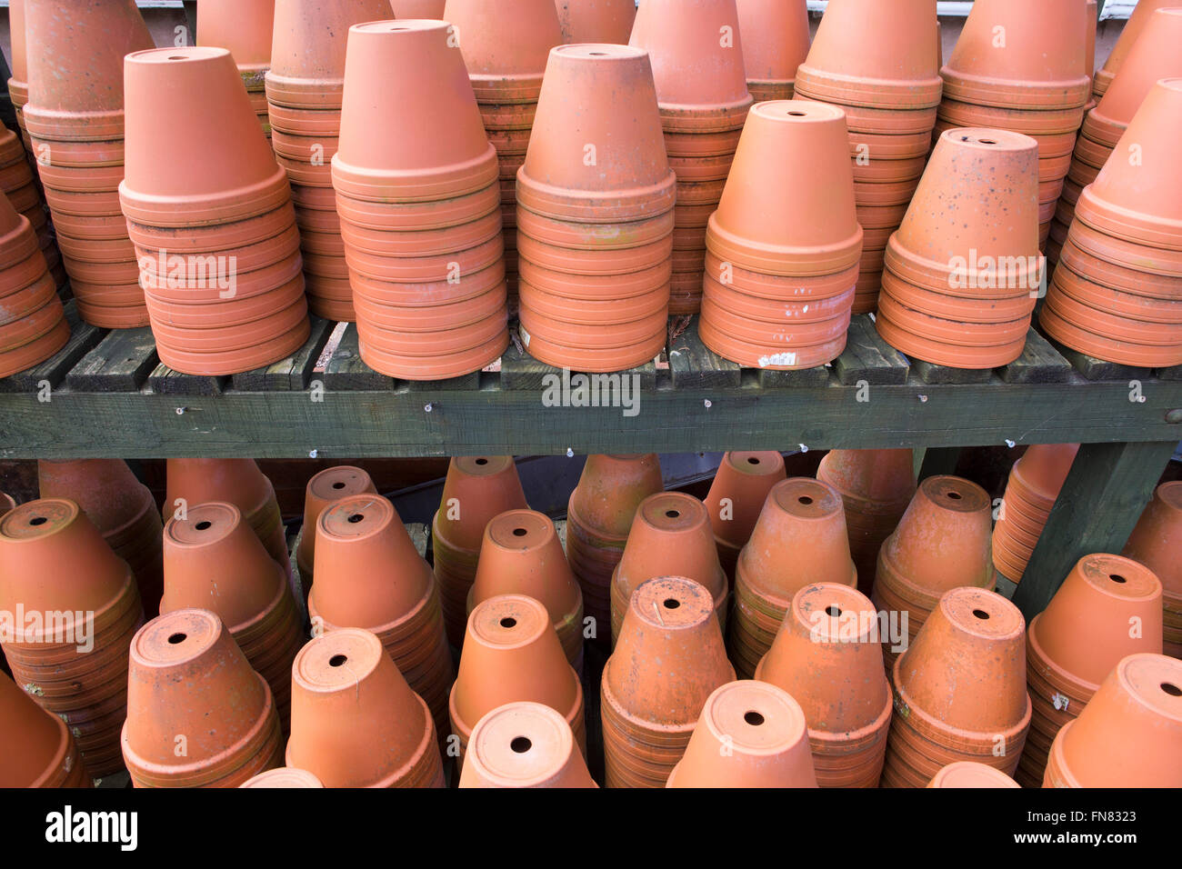 Terracotta plant pots stacked on top of each other on a shelf Stock ...