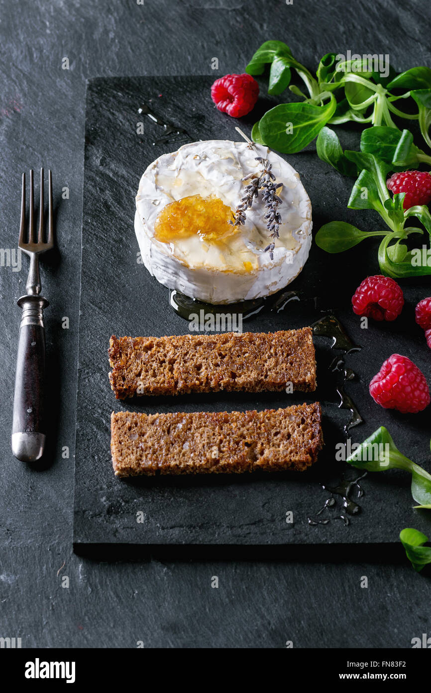 Goat cheese with honey and raspberries Stock Photo - Alamy