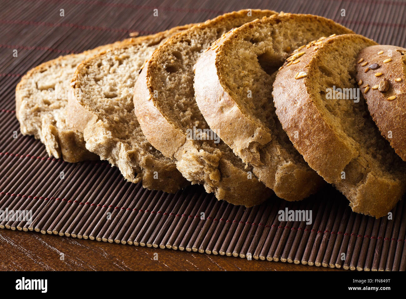 Black rye bread with sliced layer of seeds and nuts Stock Photo - Alamy