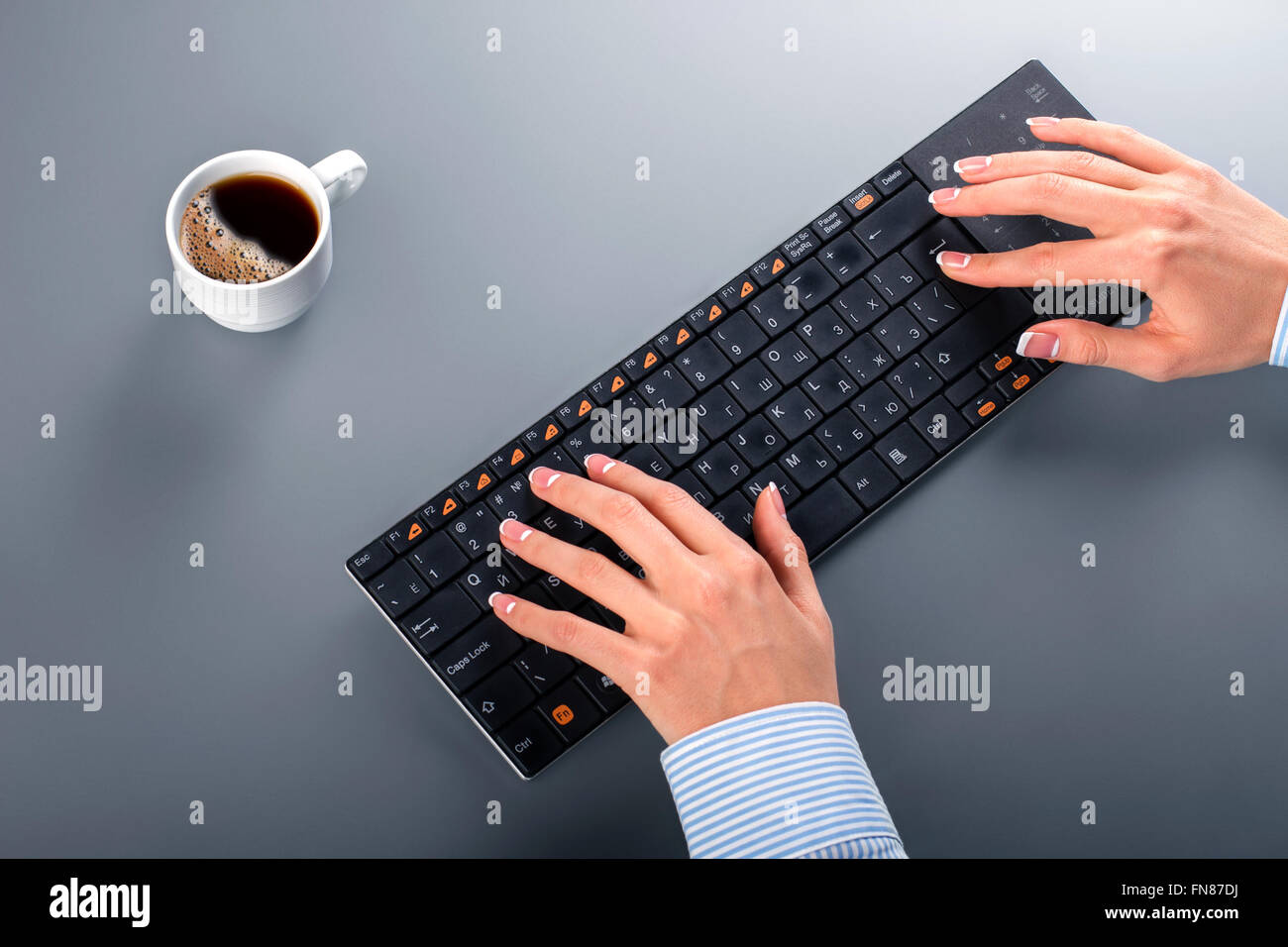 Woman's hands on wireless keyboard Stock Photo - Alamy