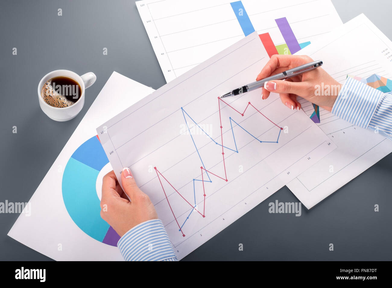 Female hands holding graphic chart Stock Photo - Alamy