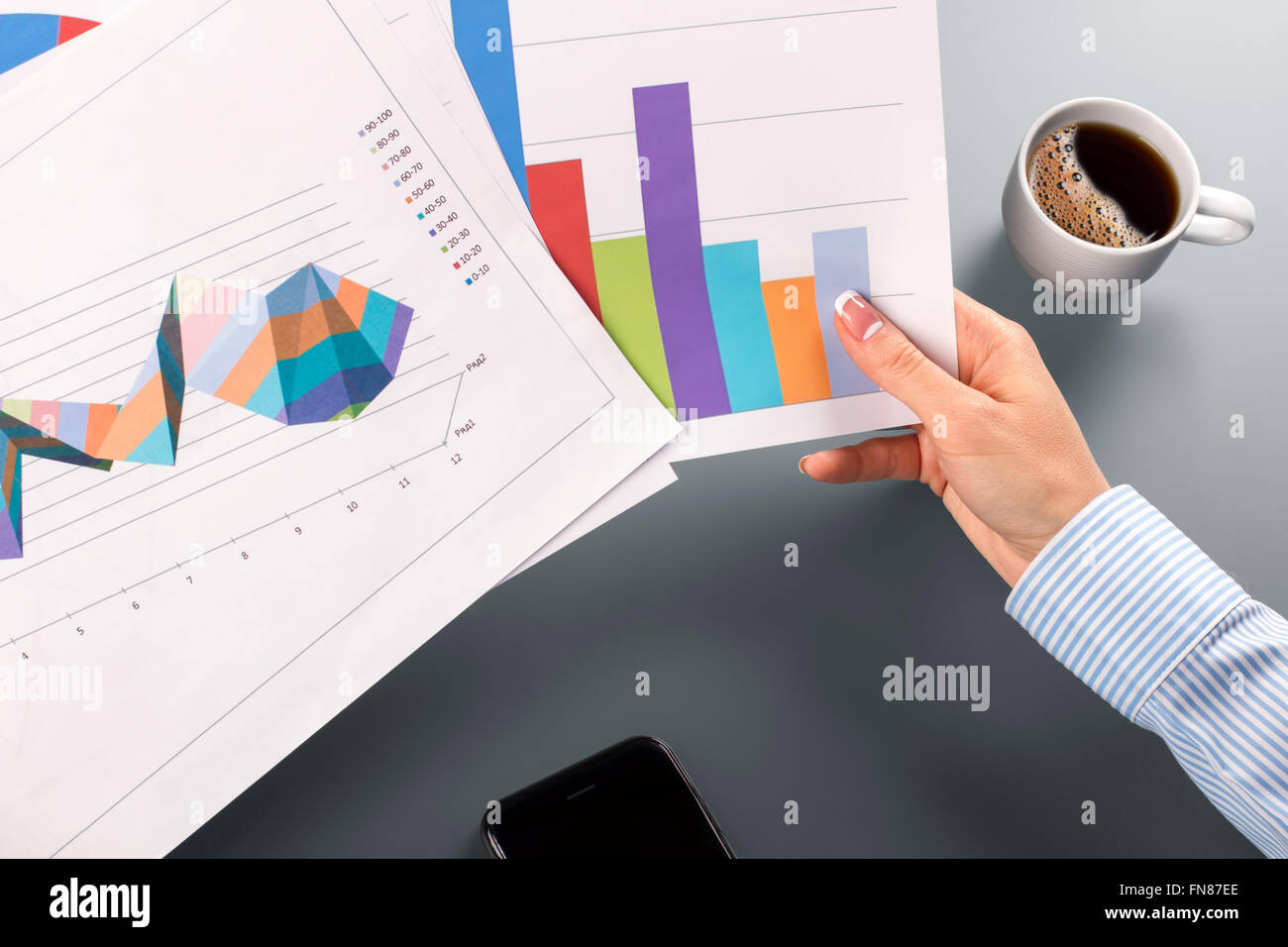 Female clerk's hands holding charts Stock Photo - Alamy