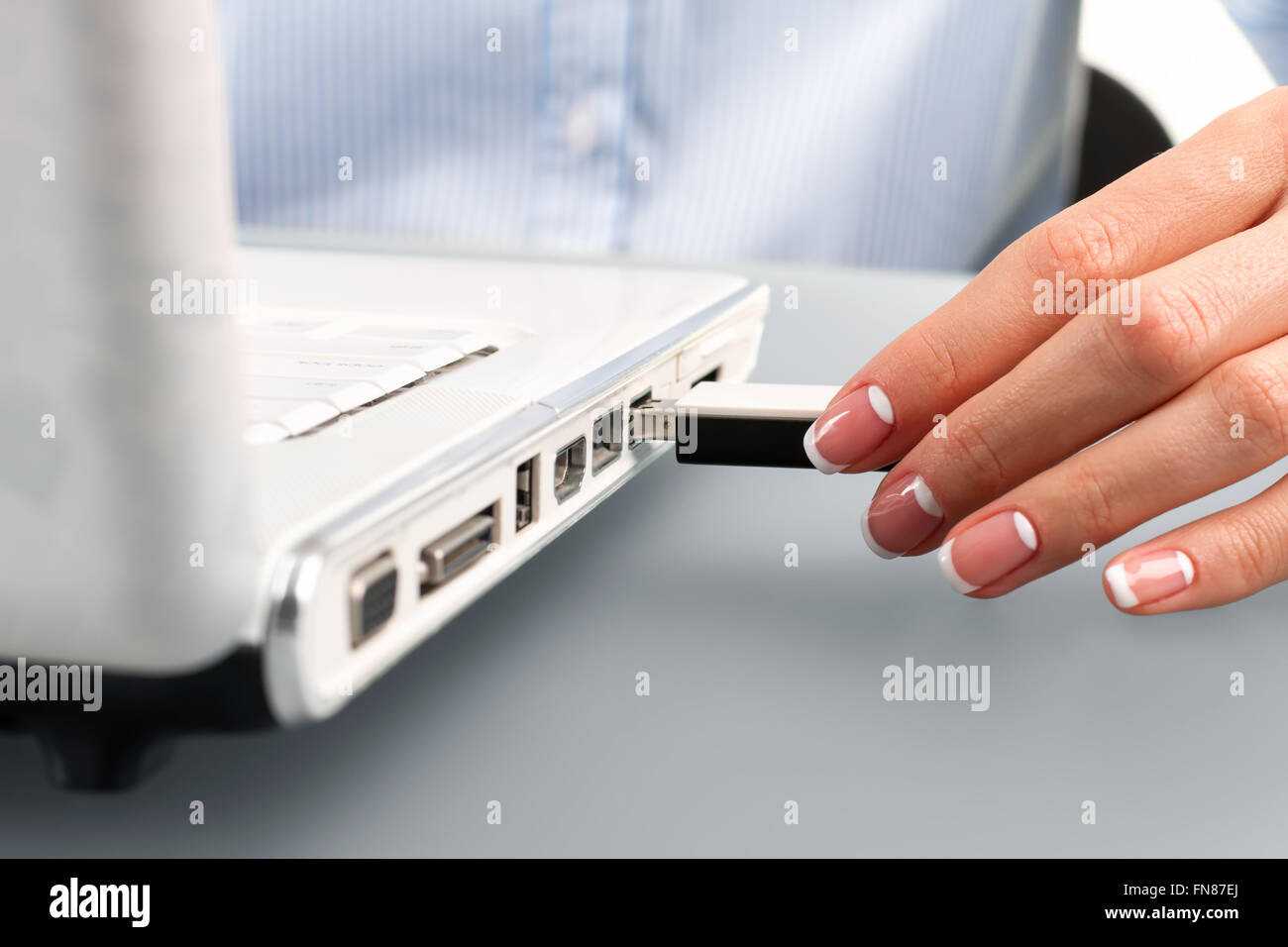 Female hand inserting flash drive Stock Photo - Alamy