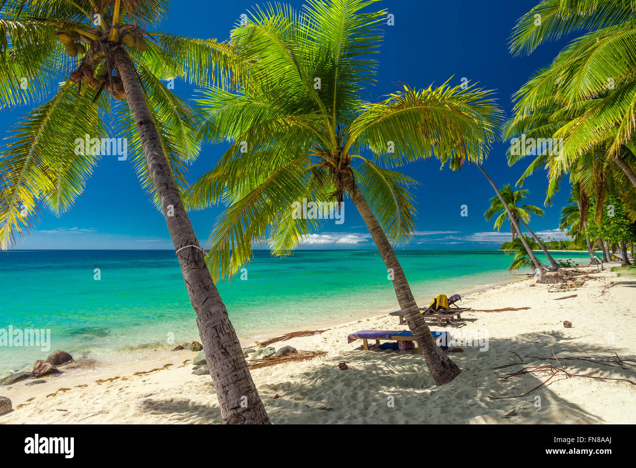 Tropical Beach With Coconut Palm Trees And Clear Lagoon On Fiji Islands